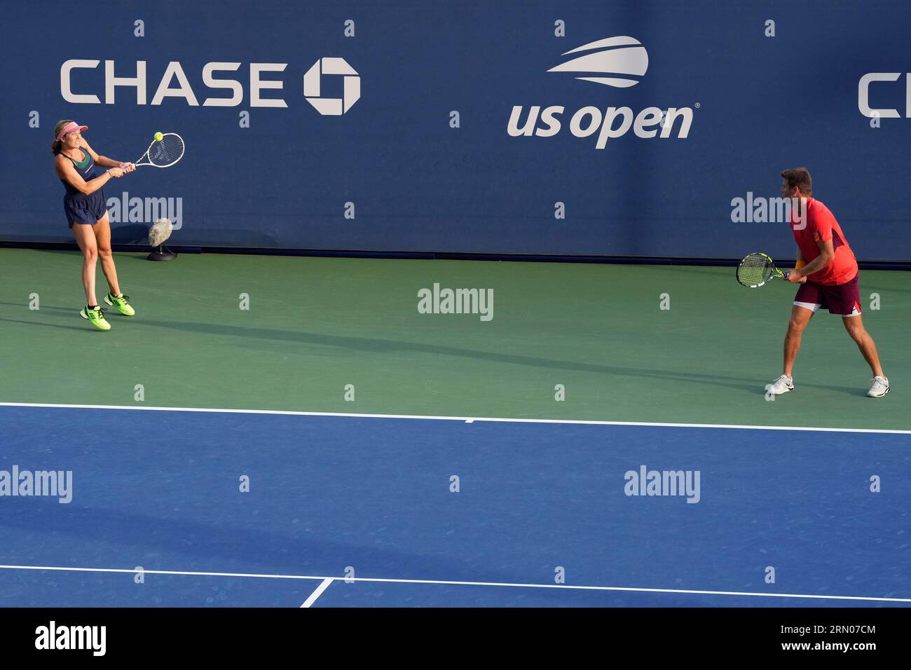 Danielle Collins and Ryan Harrison in action during a mixed doubles ...