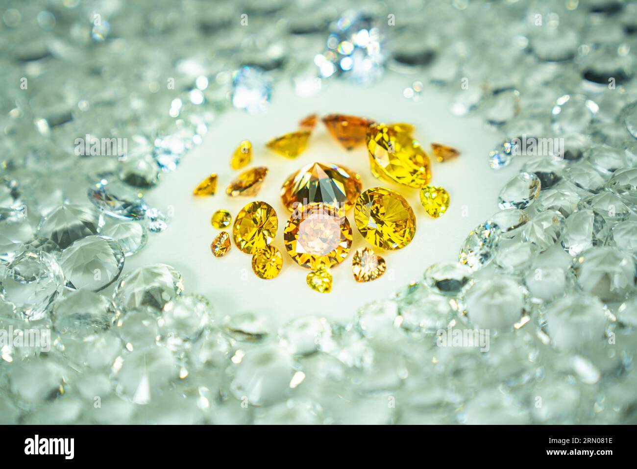 Yellow gemstones is displayed on a white background swirling around ...