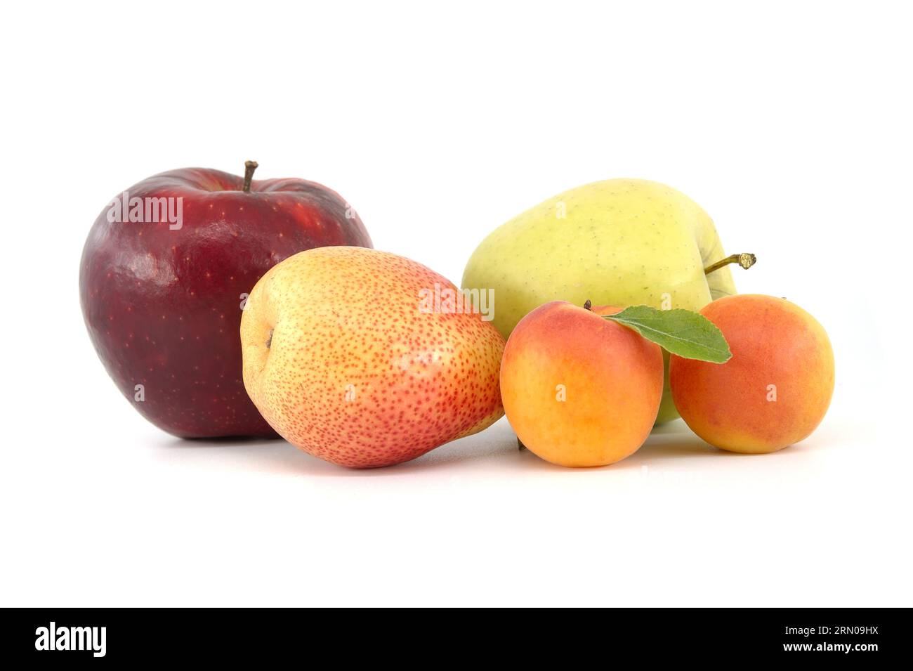 Whole ripe apricots, multicolored pear and apple isolated on a white ...