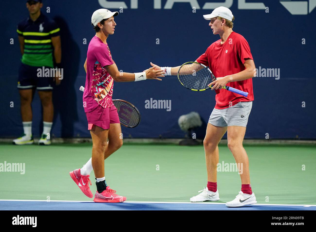 Nicholas Godsick and Ethan Quinn high five during a men's doubles match ...