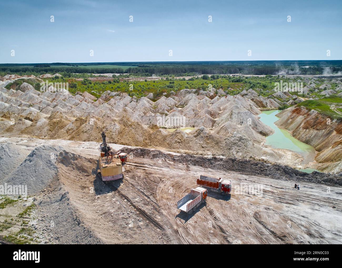 Tip trucks and shovel mining excavatorin chalk quarry Stock Photo - Alamy