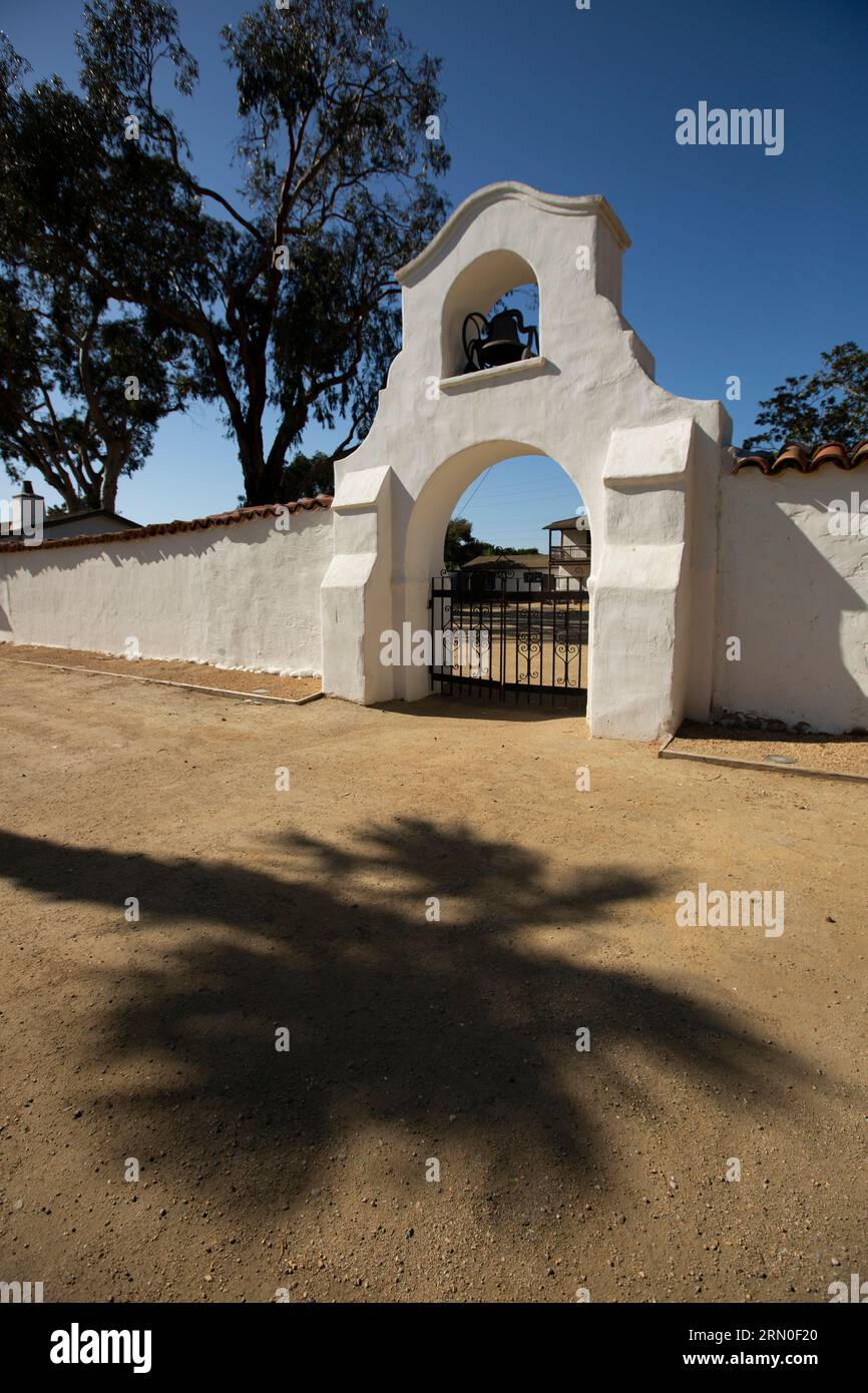 Afternoon sun shines on a historic adobe ranch building from the early ...