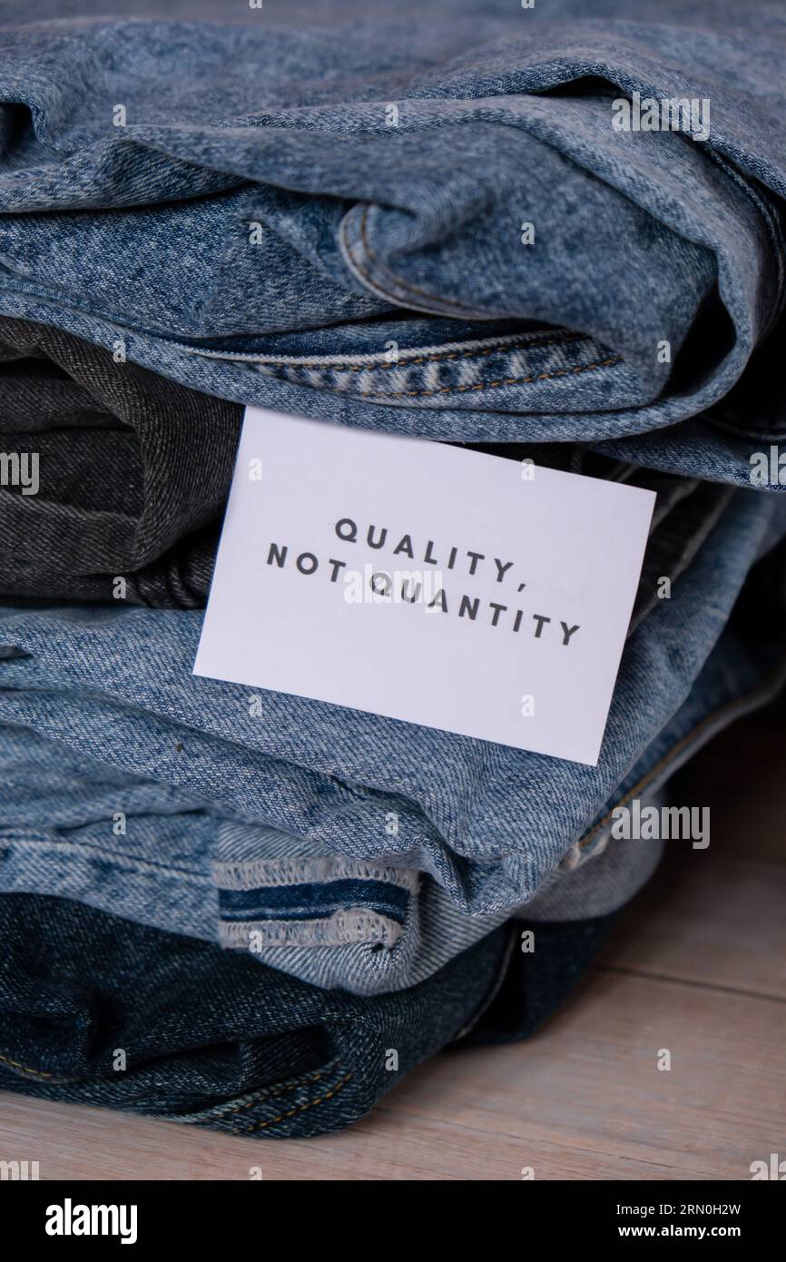 Quality not quantity text on paper note on Jeans clothes assortment ...