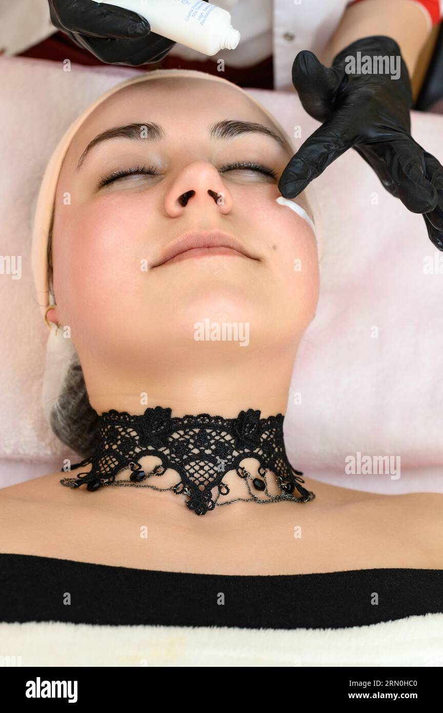 Cosmetologist in gloves applying cream hi-res stock photography and ...