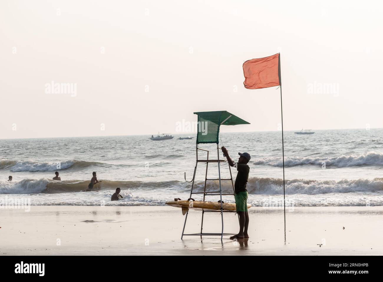 Calangute, Goa, India - January 2023: A lifeguard setting up his tall ...