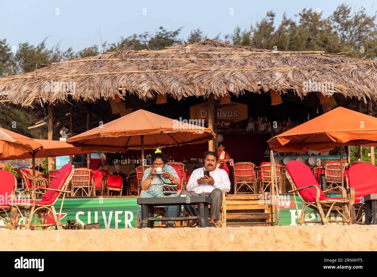 Calangute, Goa, India - January 2023: Two Indian tourists sitting at ...