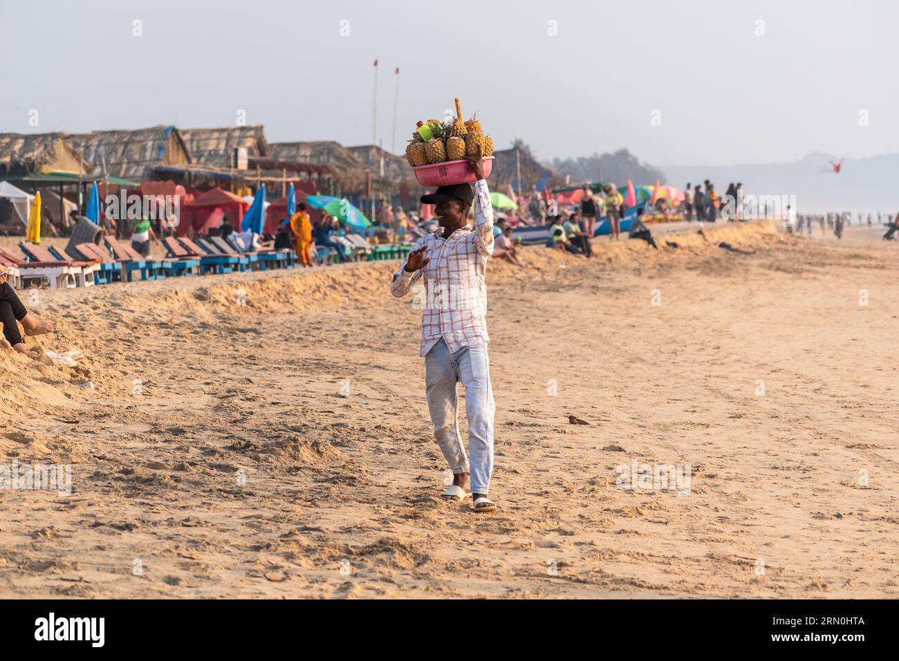Calangute, Goa, India - January 2023: An Indian street vendor carrying ...