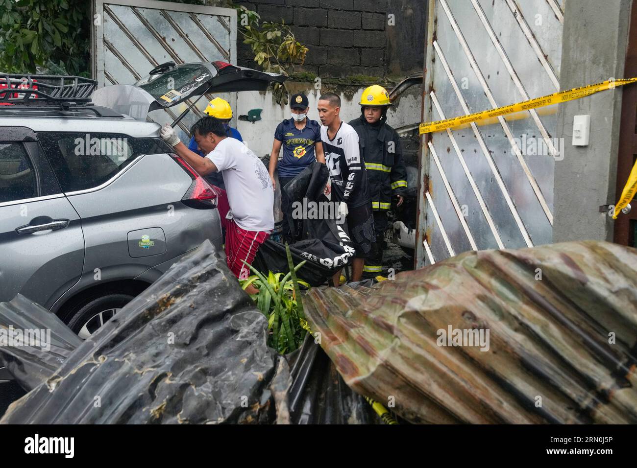 Funeral workers carry bodybag of a victim of a fire in Quezon city ...