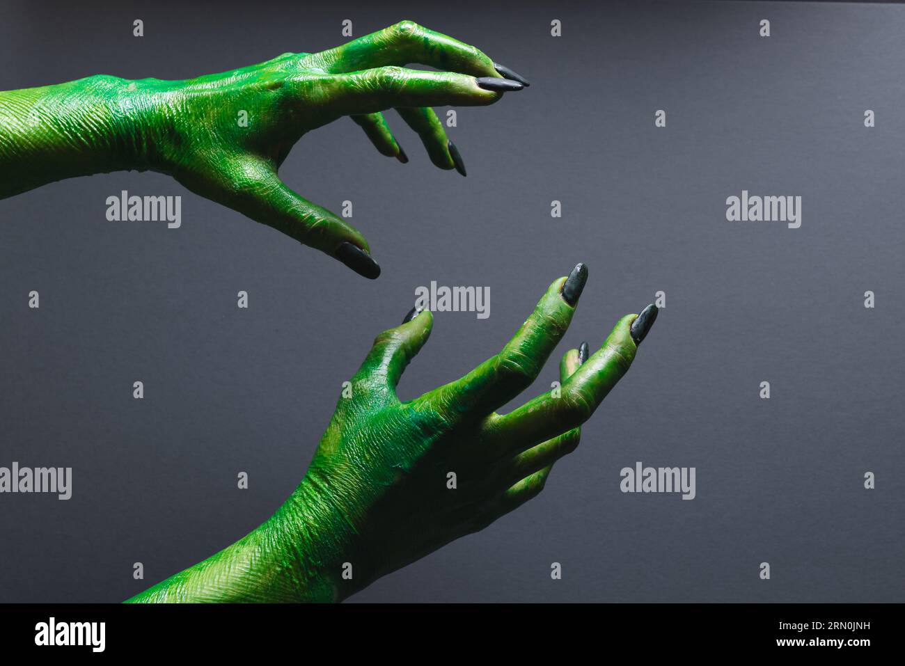Green monster hands with black nails making holding gesture on grey ...