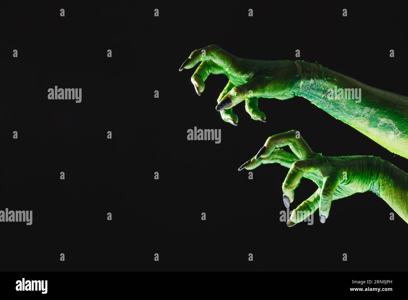 Green monster hand with black nails reaching on grey background Stock ...