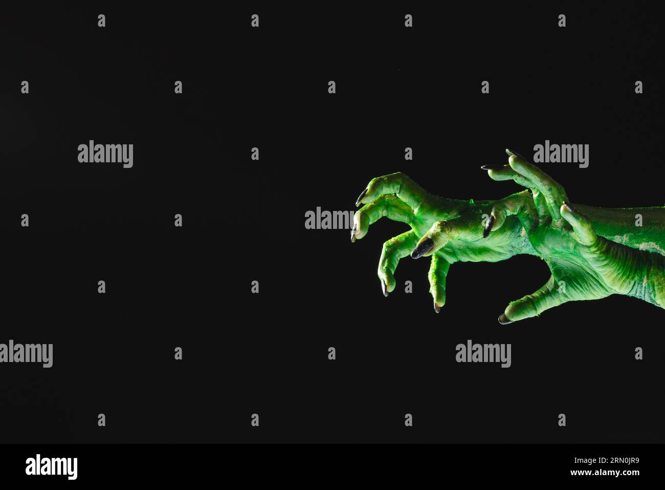 Green monster hands with black nails reaching on black background Stock ...