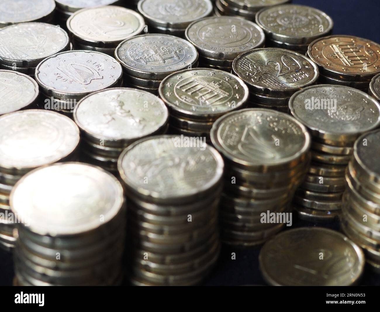 A high-angle shot of 20 cents coin stacks under the bright light Stock ...