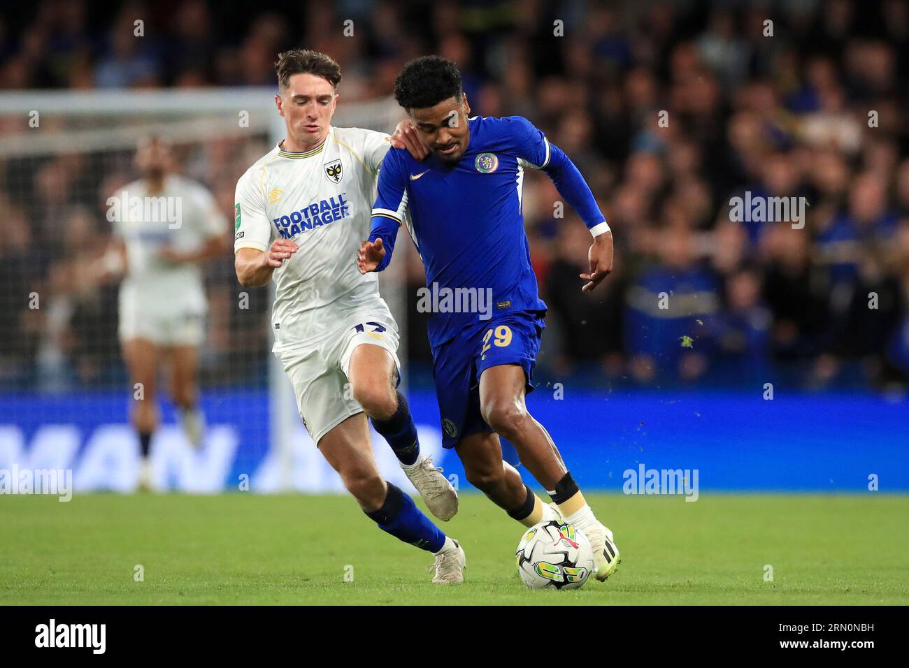 Ian Maatsen of Chelsea and Ryan McLean of AFC Wimbledon during the EFL ...
