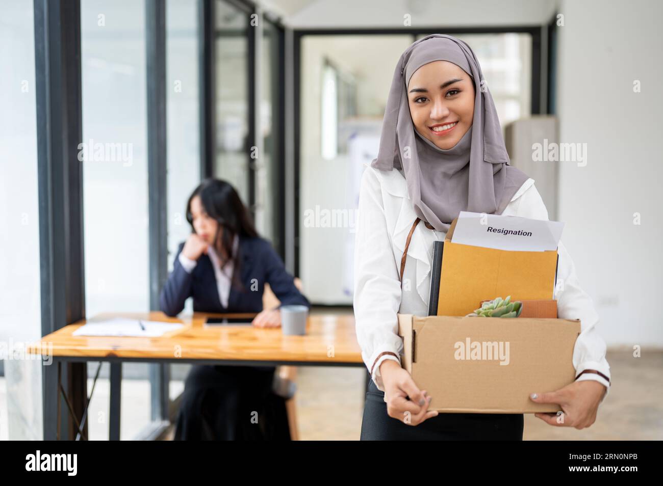 A beautiful and cheerful young Asian Muslim businesswoman wearing a ...