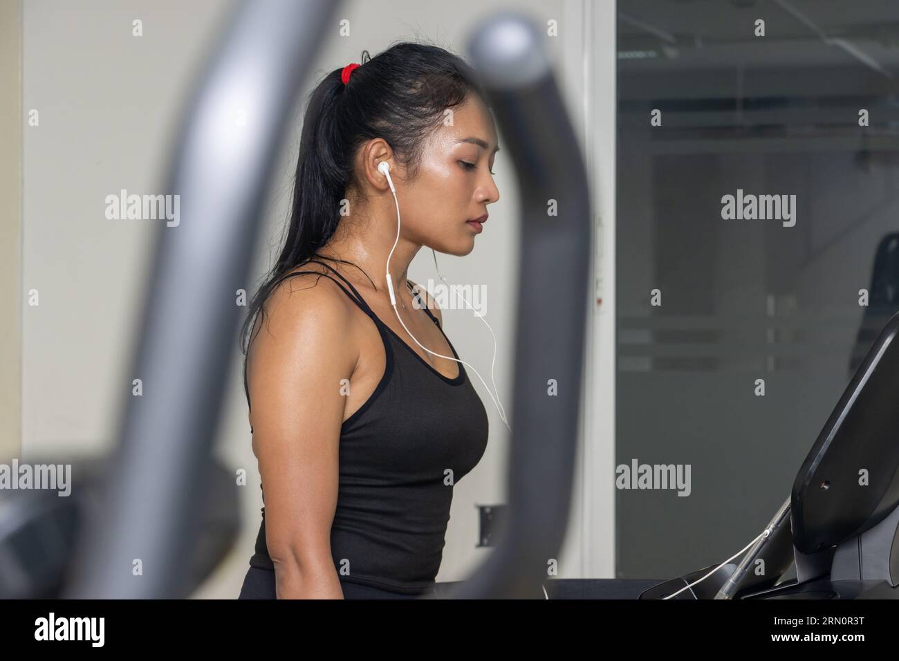 Sweaty woman uses treadmill in gym Stock Photo - Alamy