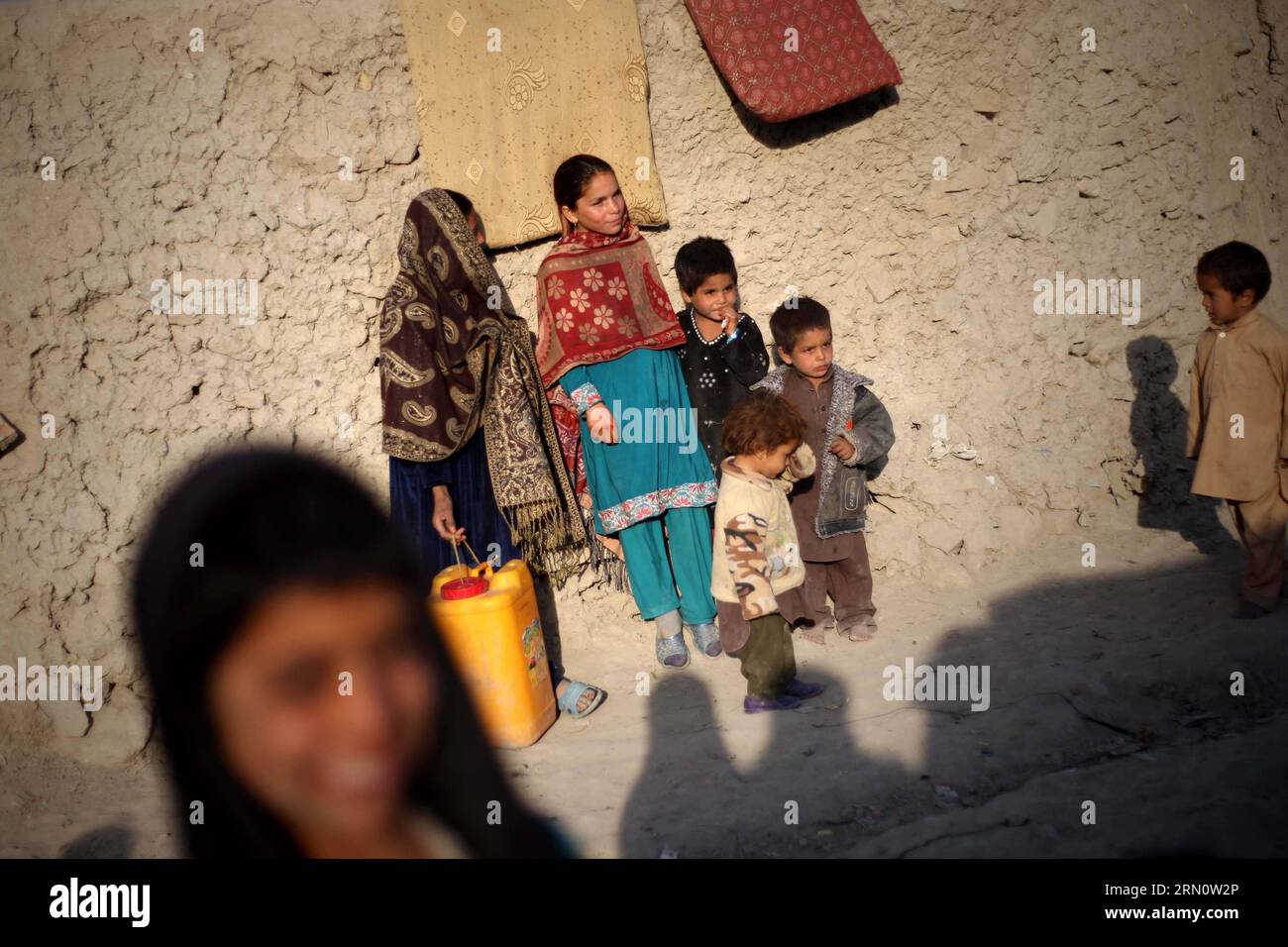 (141120) -- KABUL, -- Children gather outside their homes at a slum ...