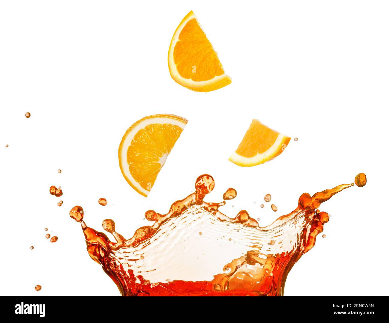 Slices of orange falling into liquid splash isolated on white ...