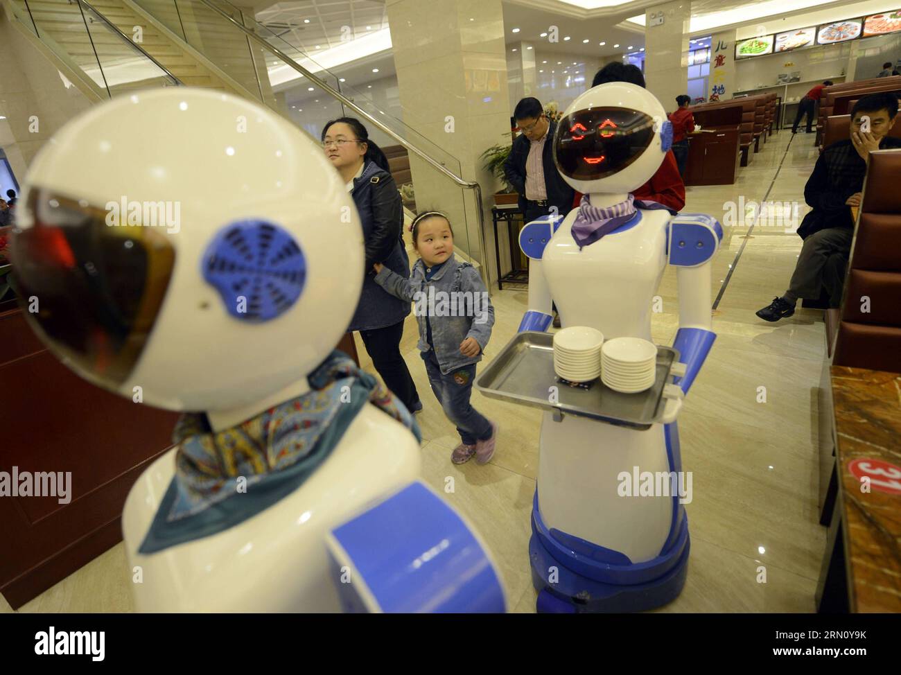 (141127) -- CIXI, Nov. 27, 2014 -- Two server robots work at a ...