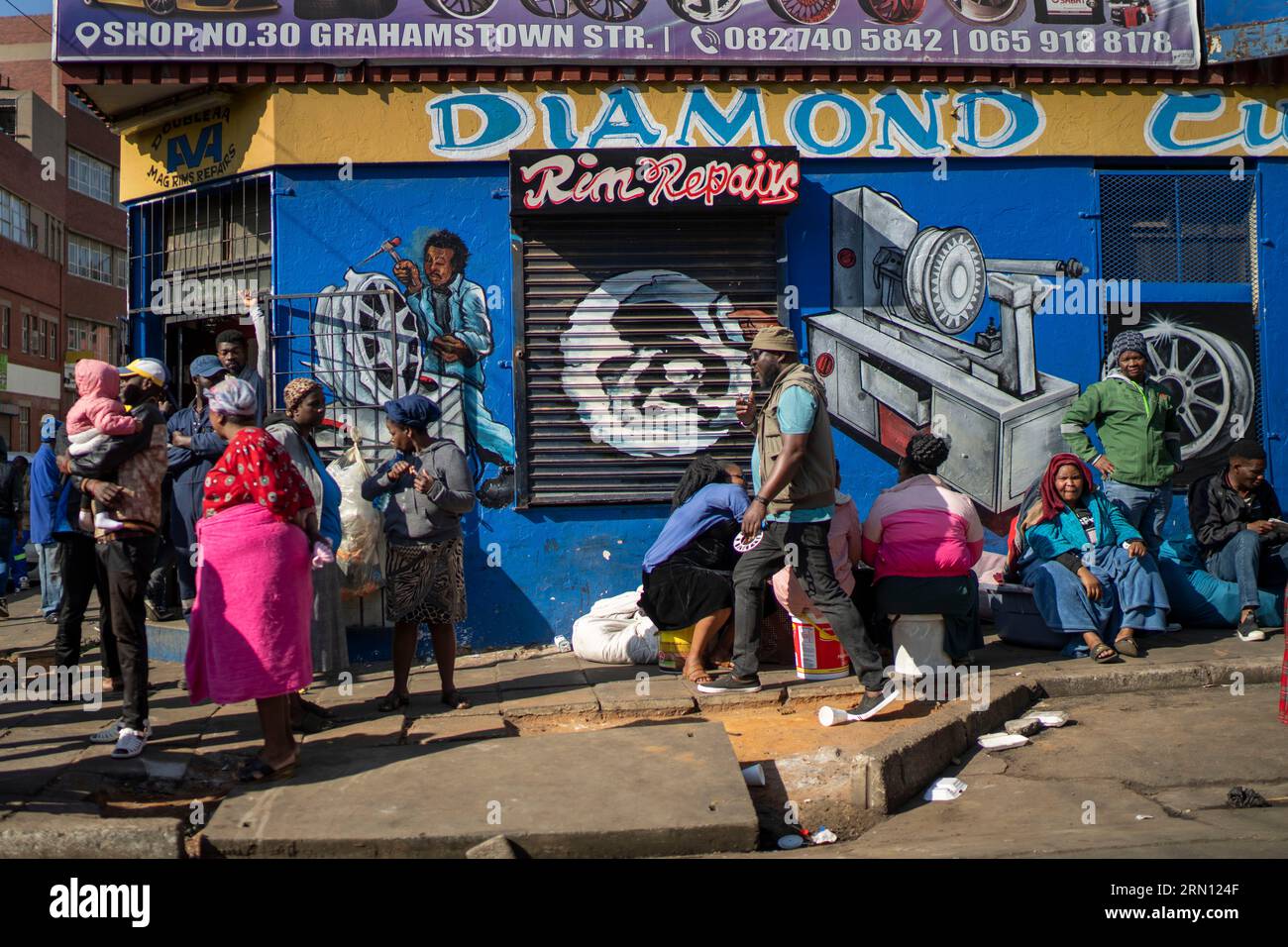 People watch rescue efforts at a multi-story building that caught fire ...