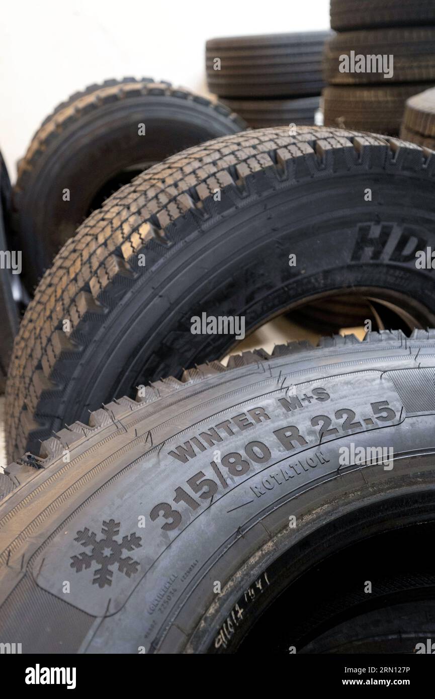 New tires in a car center: Continental winter tires for utility ...