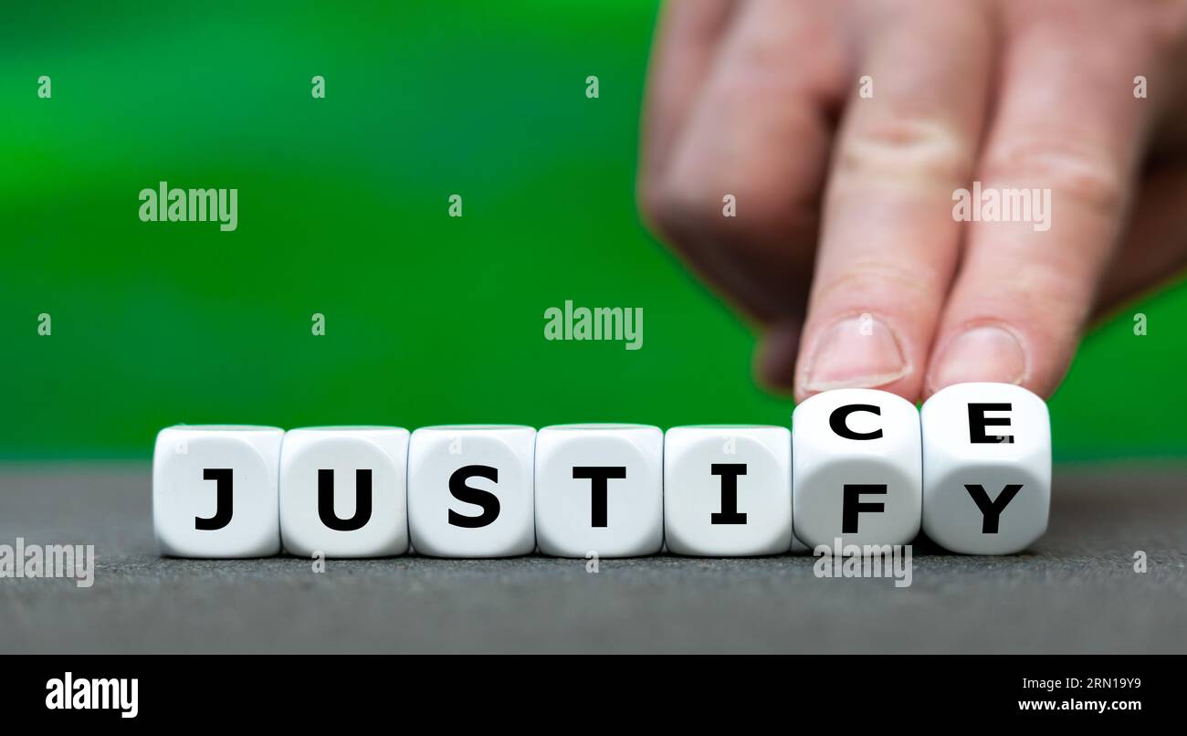 Hand turns dice and changes the word justify to justice Stock Photo - Alamy