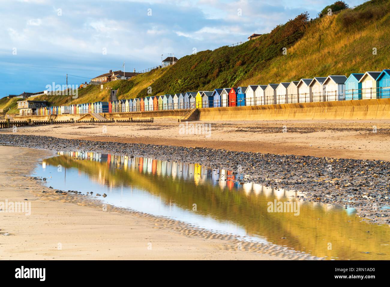 Relections of the beach huts on the beach at Mundesley in North Norfolk ...