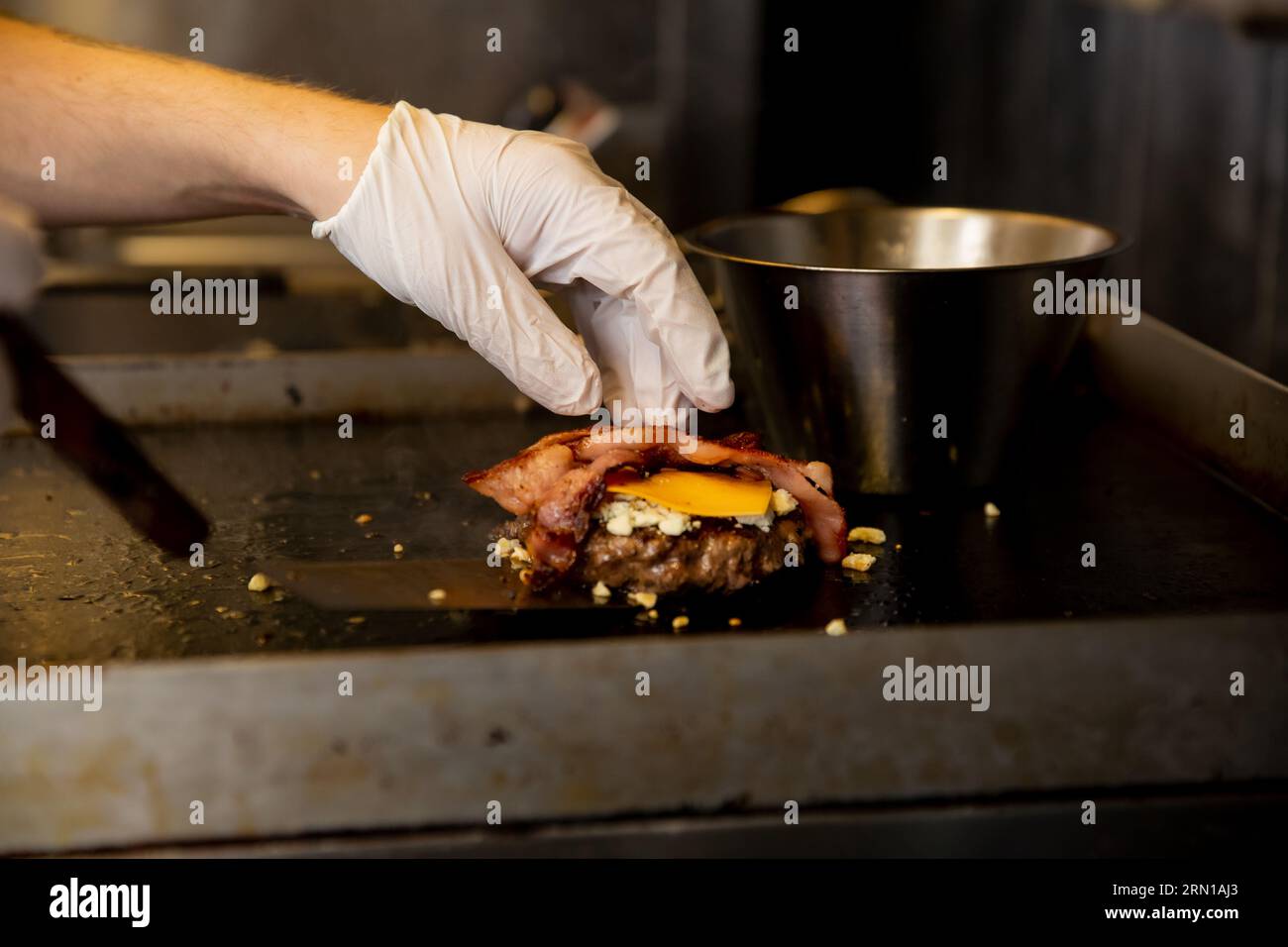 Chef cooking hamburgers, frying beef meat on pan in restaurant kitchen ...