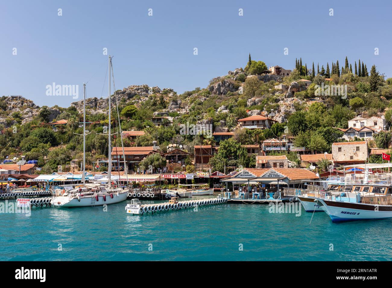 Boats moored in the harbour of beautiful Simena village, a tourist ...