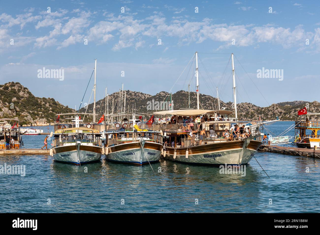 Tourist excursion boats moored in Simena village harbour, Simena ...