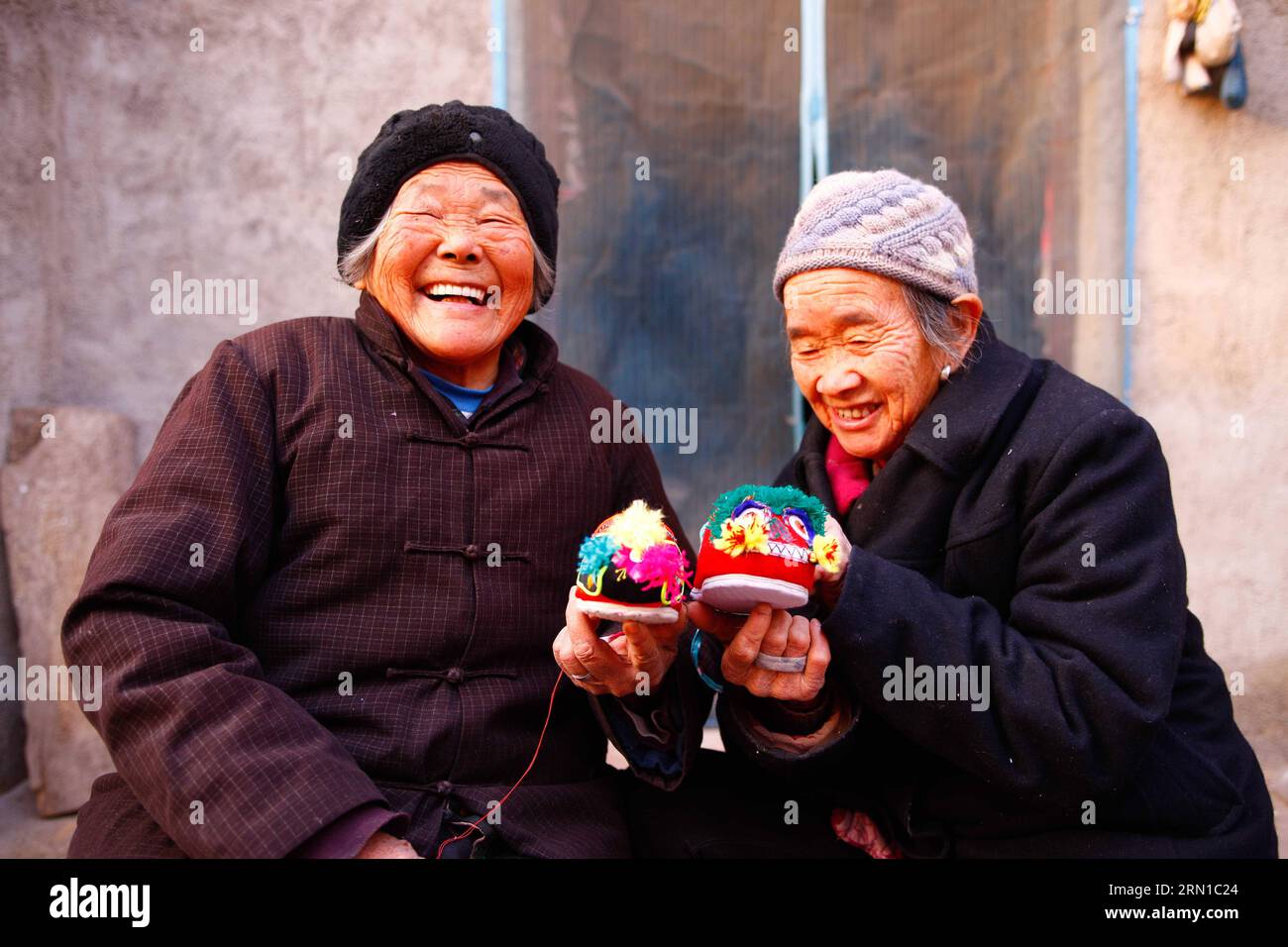 Sun Jinglan (L) and Li Xiuying show their tiger shoes at Sun Jinglan s ...