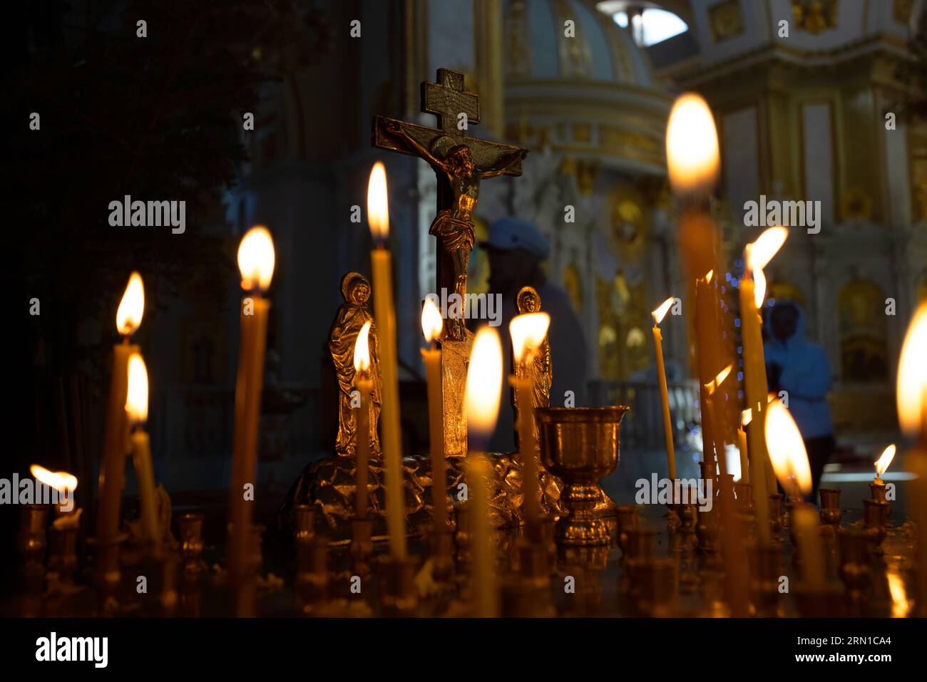 Concept of Christian religion. Cross with crucifix in focus, lit wax ...