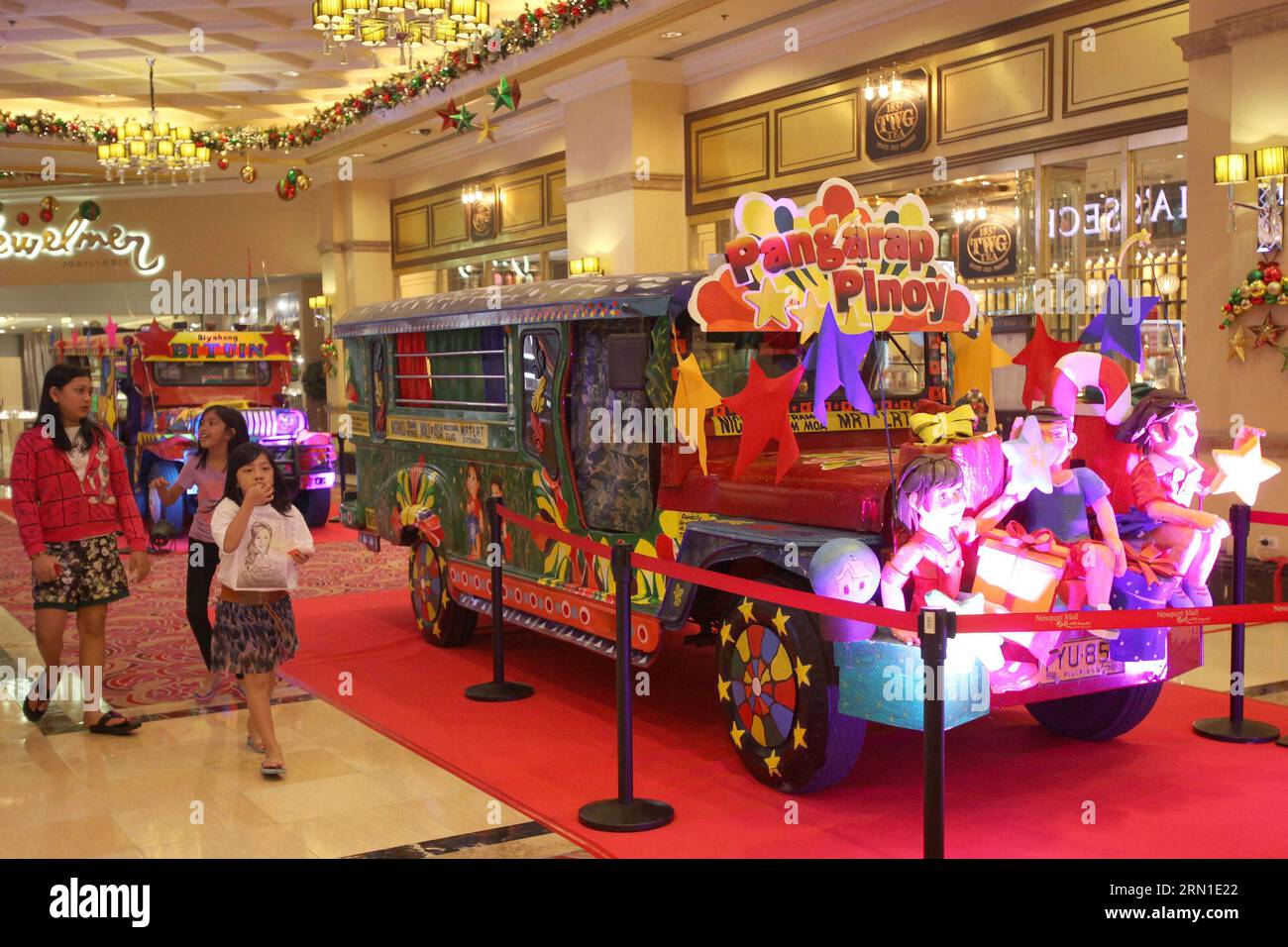 People walk past a colorful jeepney during the Jeepney Design Challenge ...
