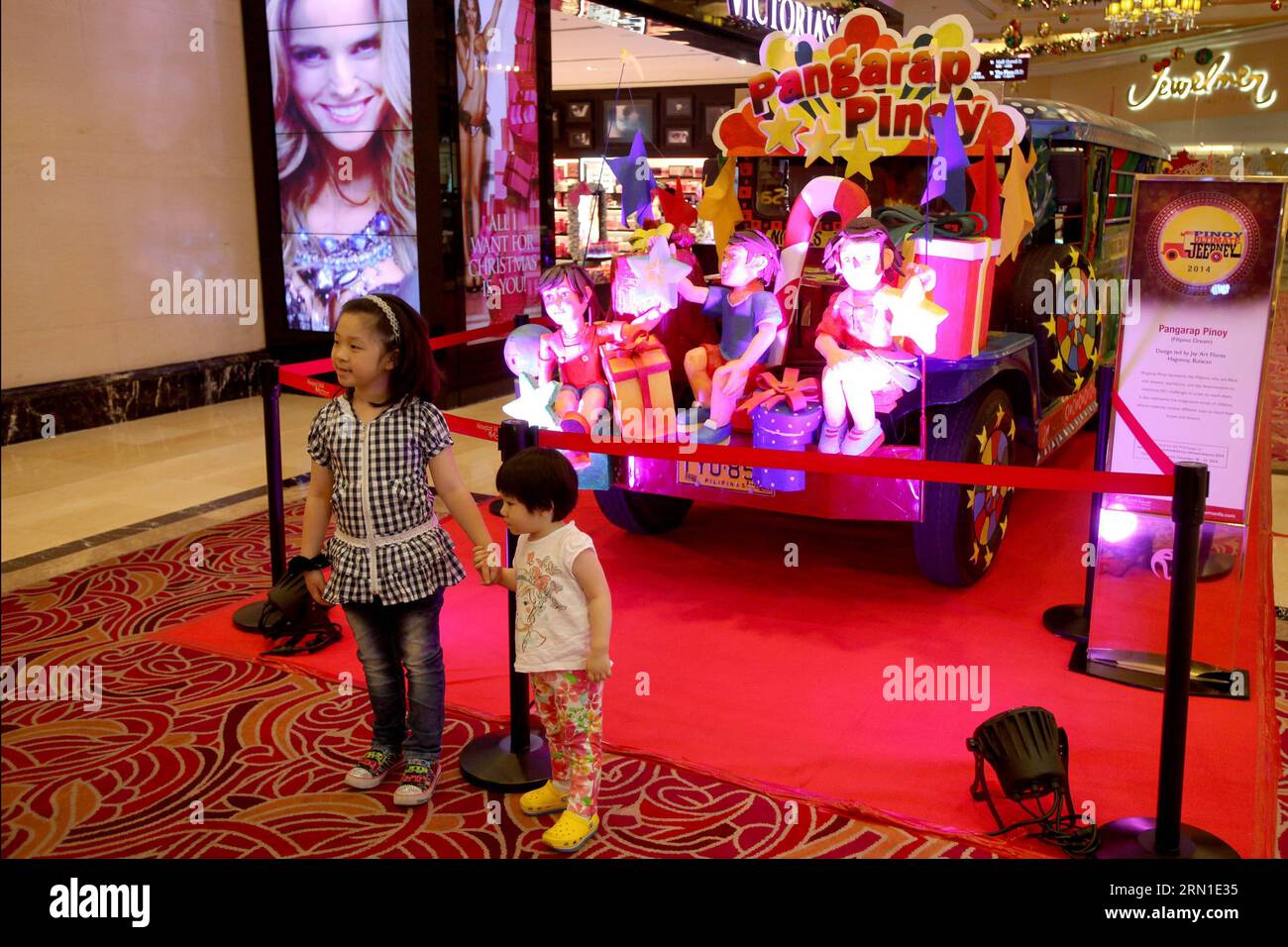 Children stand by a colorful jeepney during the Jeepney Design ...