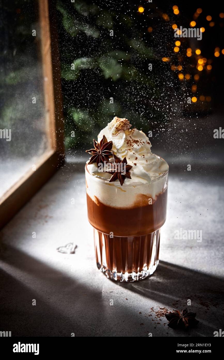 Glass of hot chocolate with whipped cream. Sugar powder snow. Christmas ...