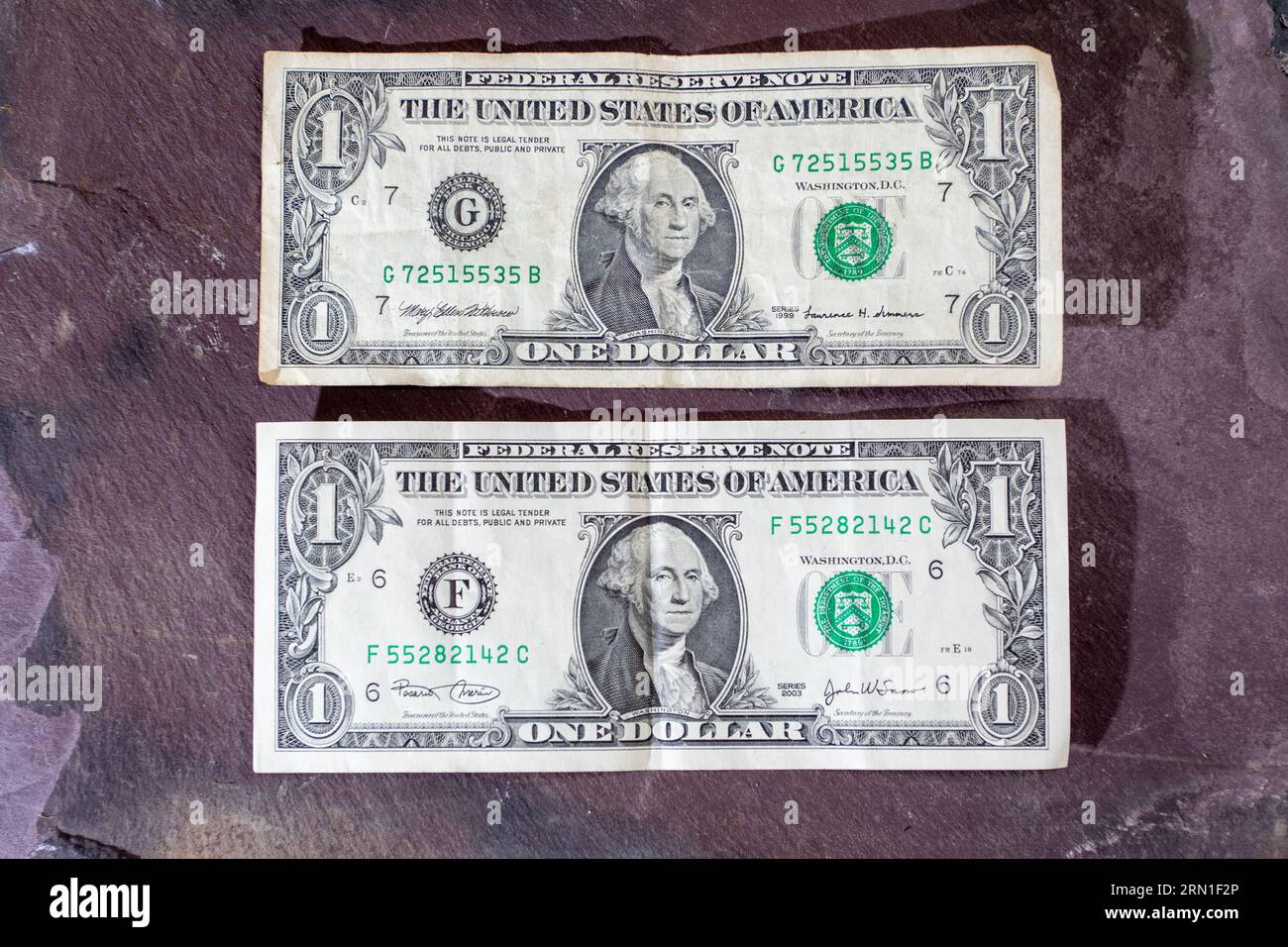 Two one dollar bills face up showing George Washington America's first ...