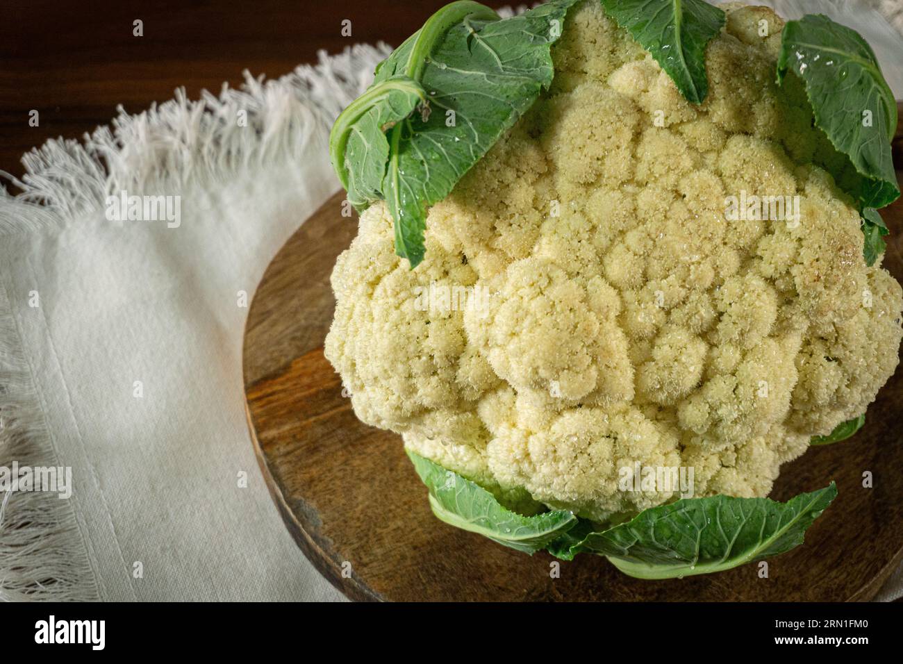 Whole head of the fresh raw cauliflower with some leaves Stock Photo ...