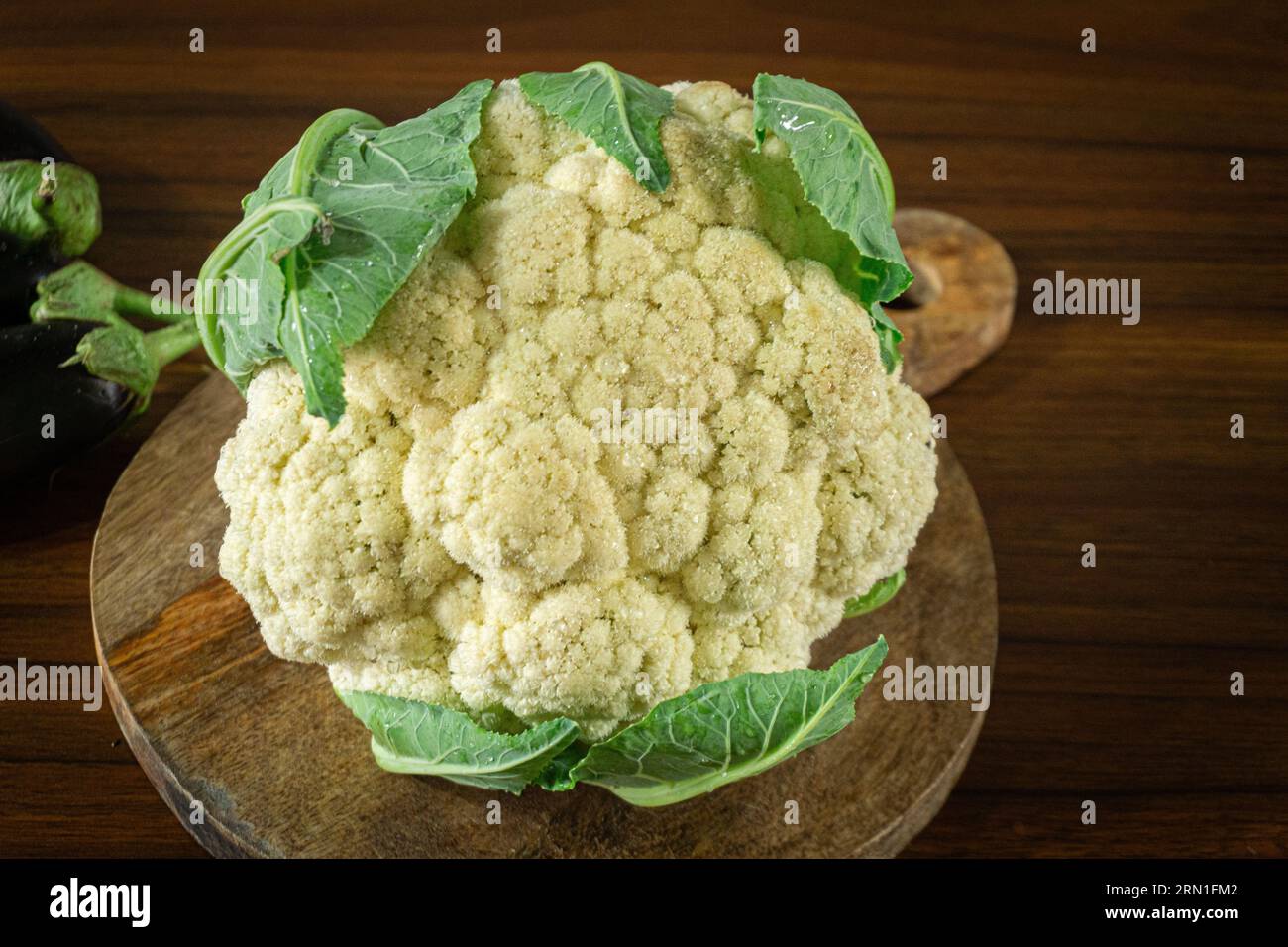 Whole head of the fresh raw cauliflower with some leaves Stock Photo ...
