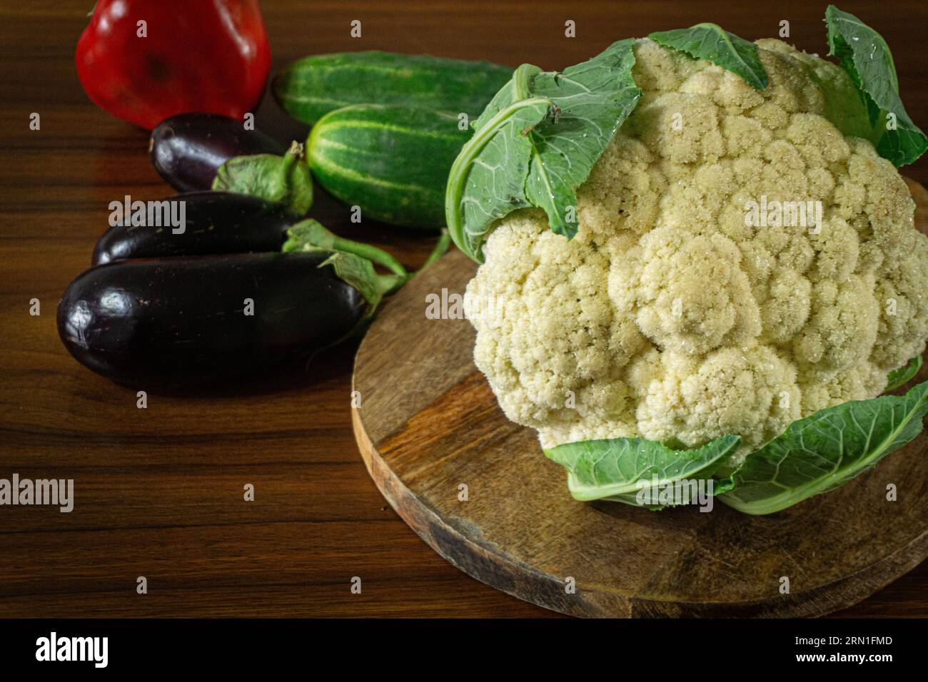 Whole head of the fresh raw cauliflower with some leaves Stock Photo ...