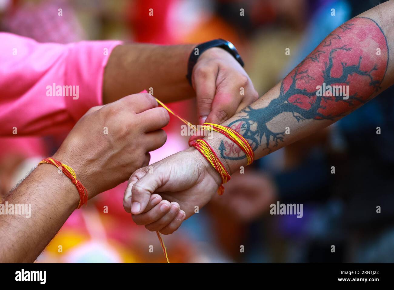 Kathmandu, Nepal. 31st Aug, 2023. A Hindu priest ties a sacred thread ...