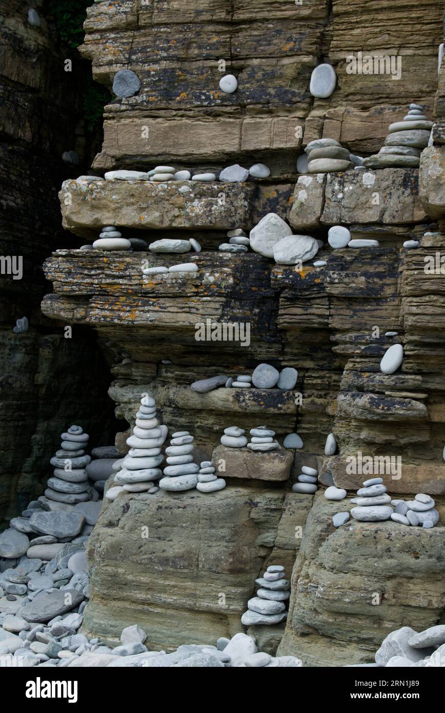 Large pebbles placed on cliff ledges, Orkney Islands Stock Photo - Alamy