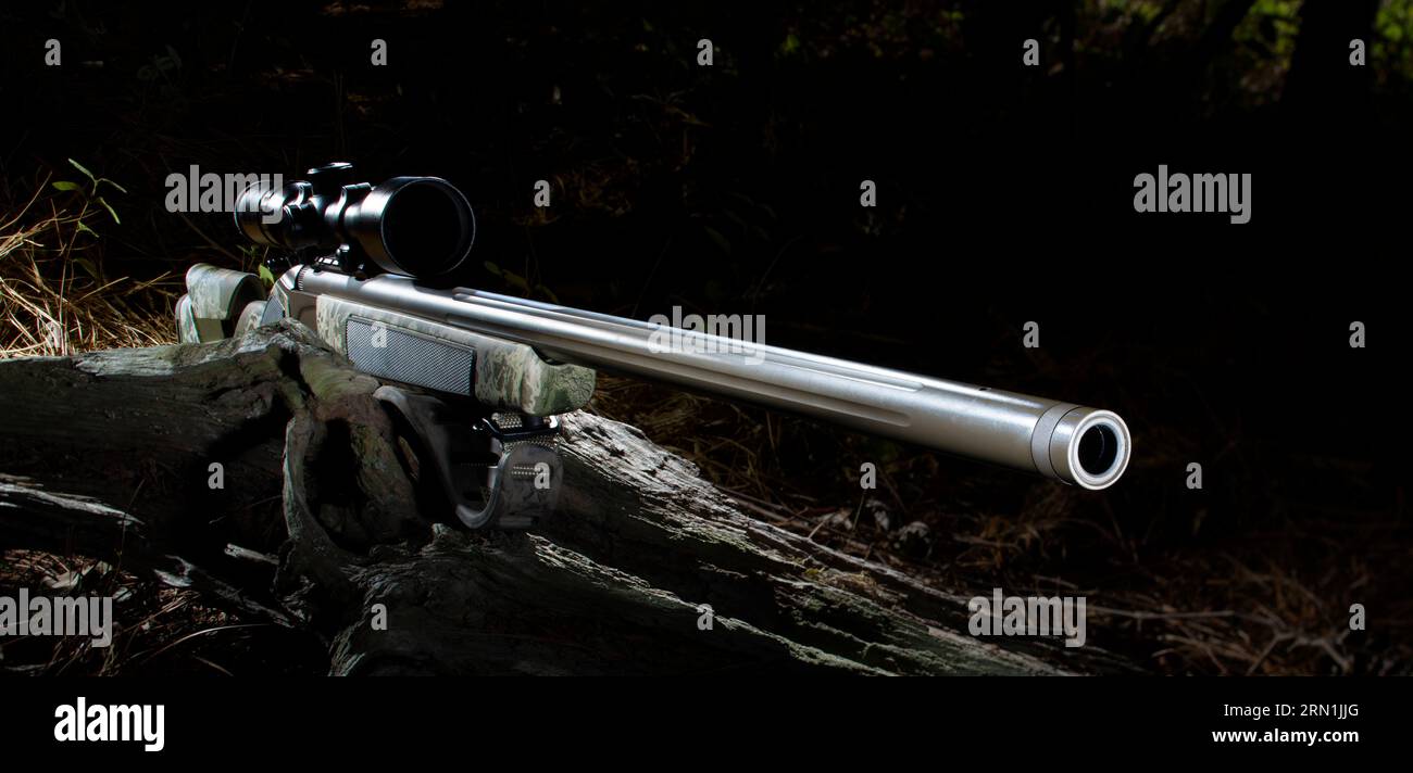 Large inline muzzleloader with rifle scope seen from the muzzle end in ...