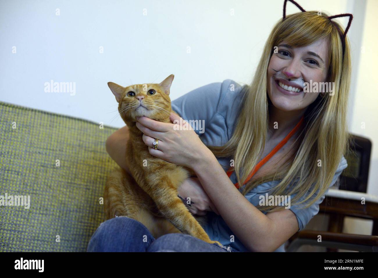A volunteer interacts with a cat at the Singapore s Cat Museum, Jan. 9 ...