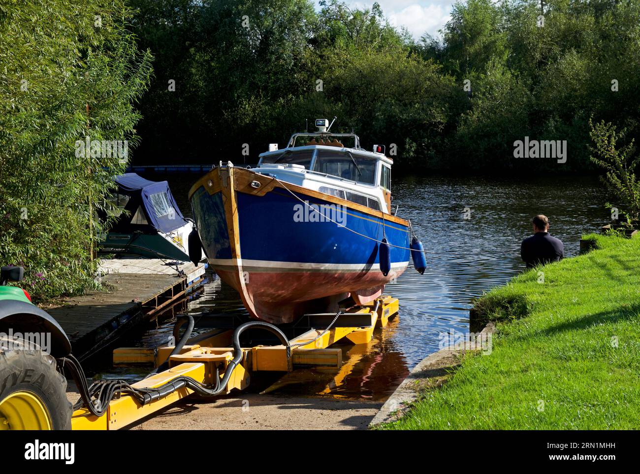 Boat being launched, by tractor, onto the River Ouse, at Acaster Maine ...