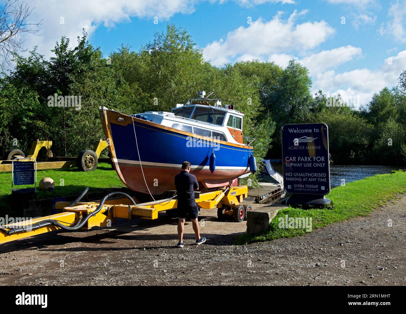 Boat being launched, by tractor, onto the River Ouse, at Acaster Maine ...
