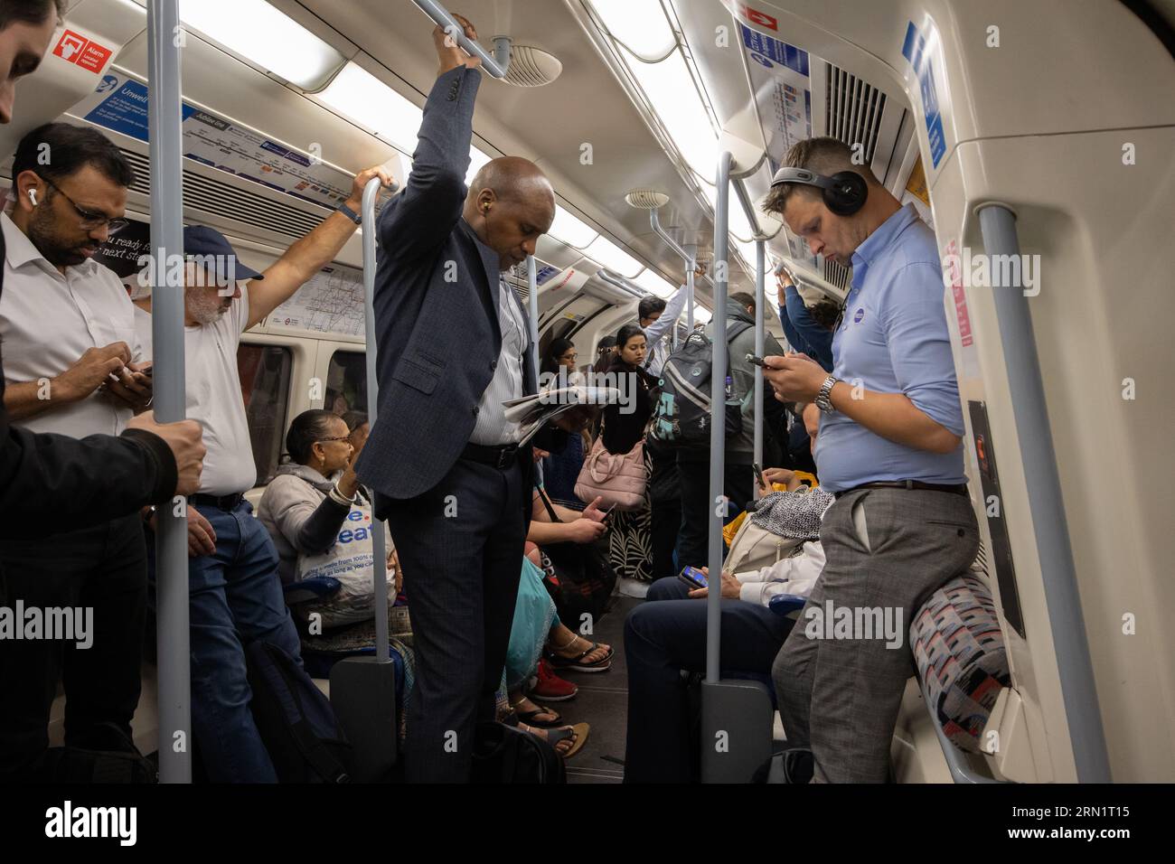 A busy carriage of commuters on the London Underground returning to ...