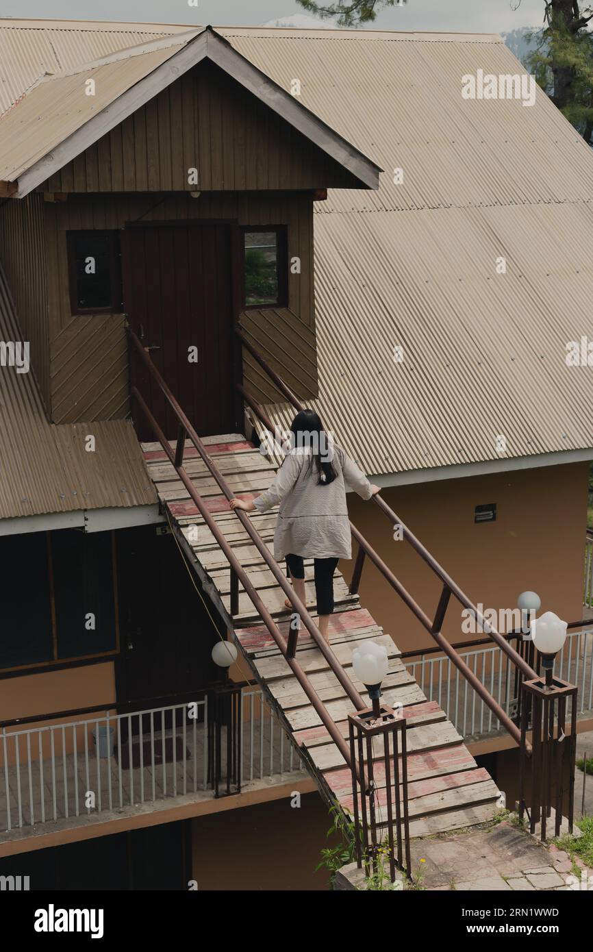 A young adult female ascending a set of steps leading up to a ...