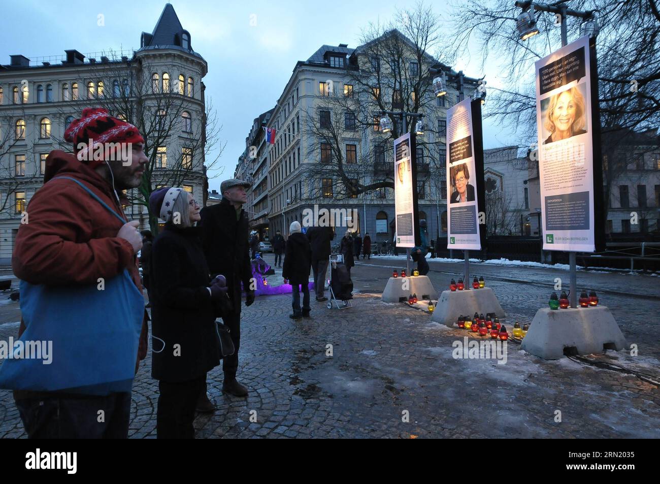 People read posters that tell the stories of Swedish Jews who were ...