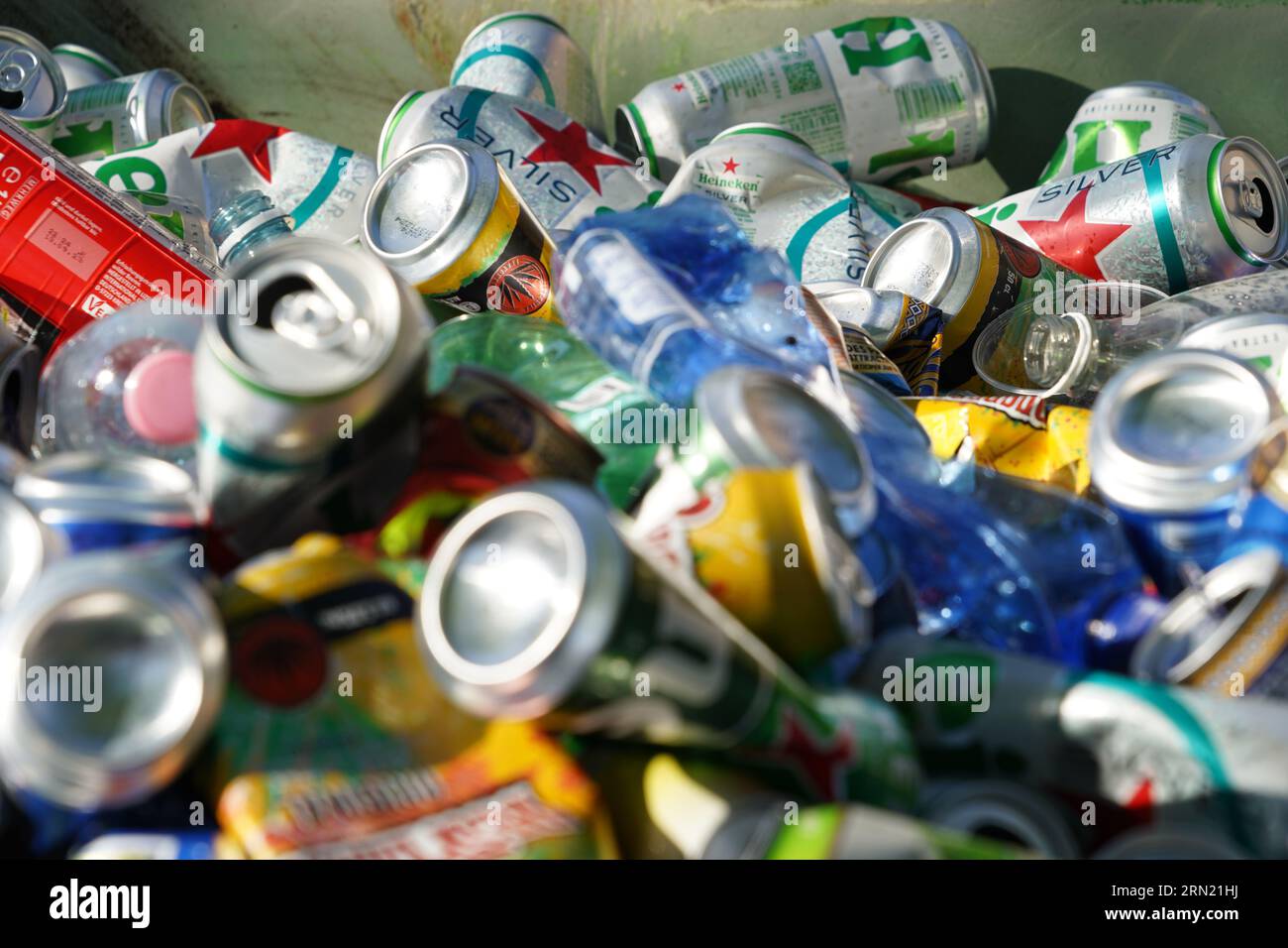 Waste plastic bottles and aluminium cans from beverages as a background ...