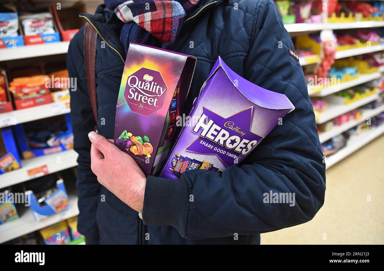 England, Canterbury: man with boxes of Quality Street and Cadbury ...