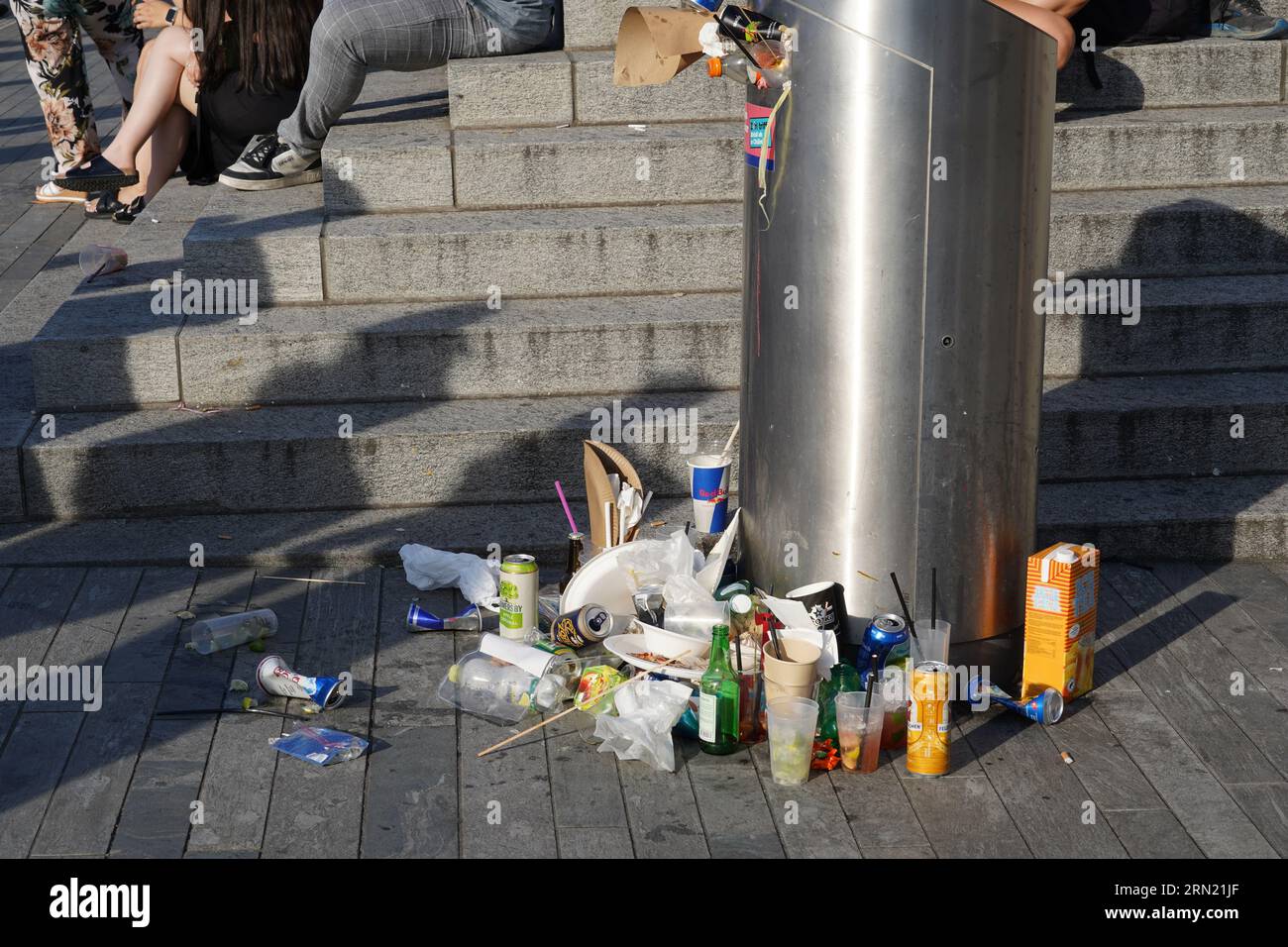 Food rubbish in and around public garbage bin in the street Stock Photo ...